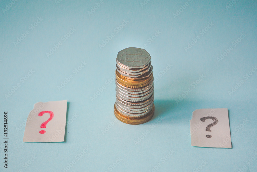 A question mark and a stack of coins. Stock Photo | Adobe Stock
