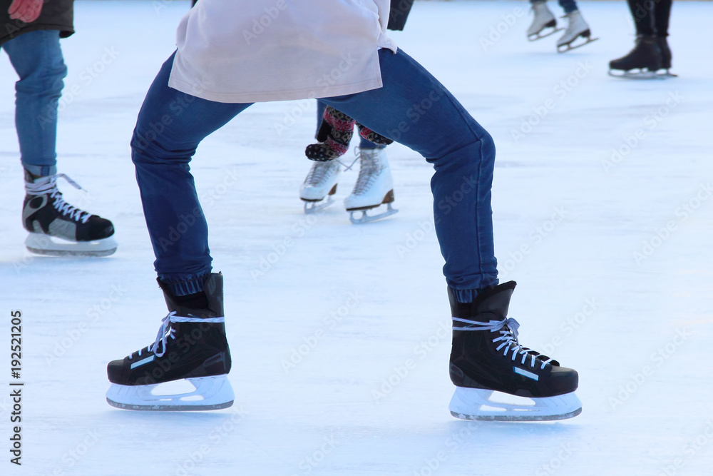 feet on the skates of a person rolling on the ice rink Stock Photo ...