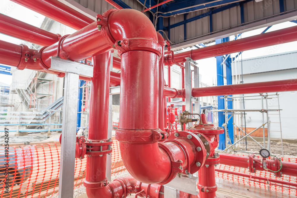 Red pipeline off fire pump house at power plant. Stock Photo | Adobe Stock