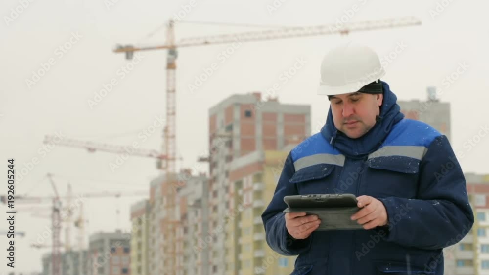 Foreman with pad at major construction project Stock Video | Adobe Stock