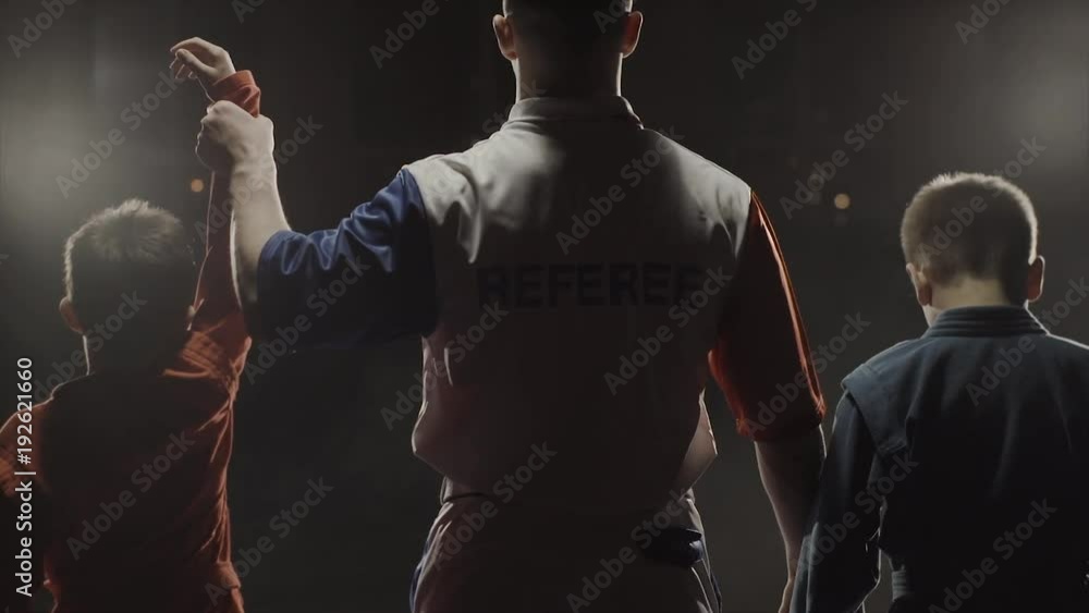 Video Stock Rear view of the boys athletes and referee who raises the ...
