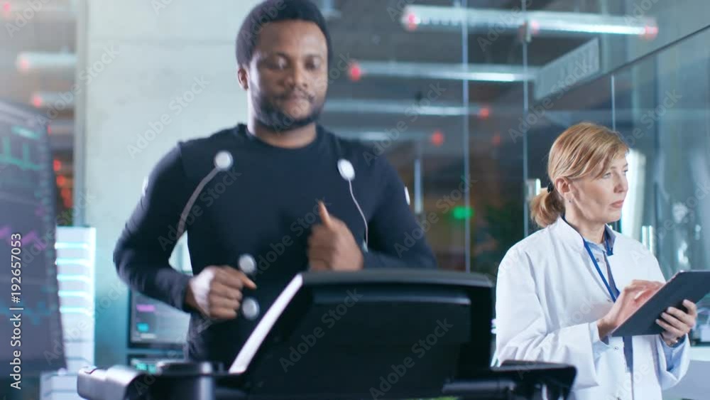 Male Athlete Runs on a Treadmill with Electrodes Attached to His Body ...