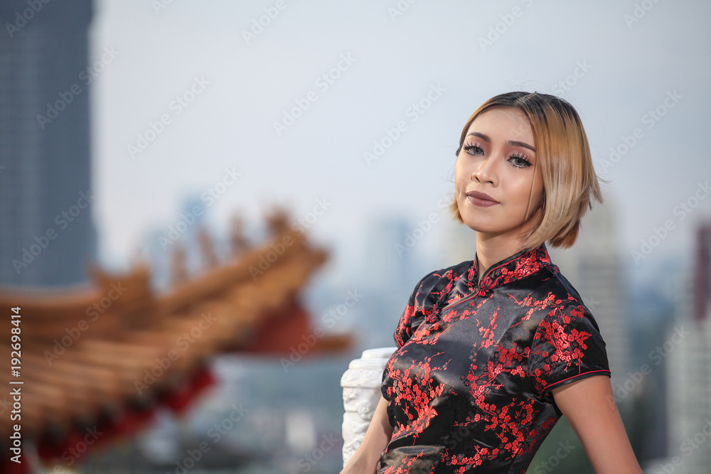 asian lady wearing traditional cheongsam dress with temple and lantern ...