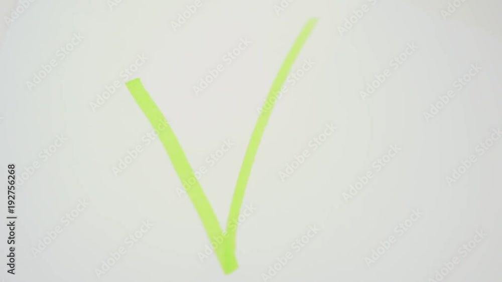 Female draws green check mark on paper Stock Video | Adobe Stock