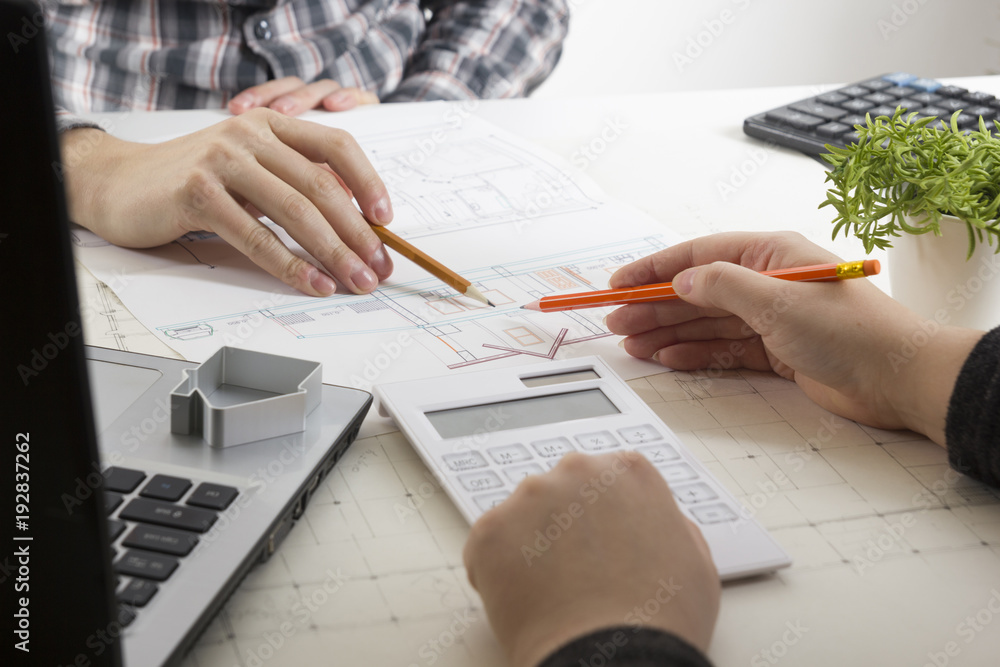 Architects working on blueprint, real estate project. Architect ...