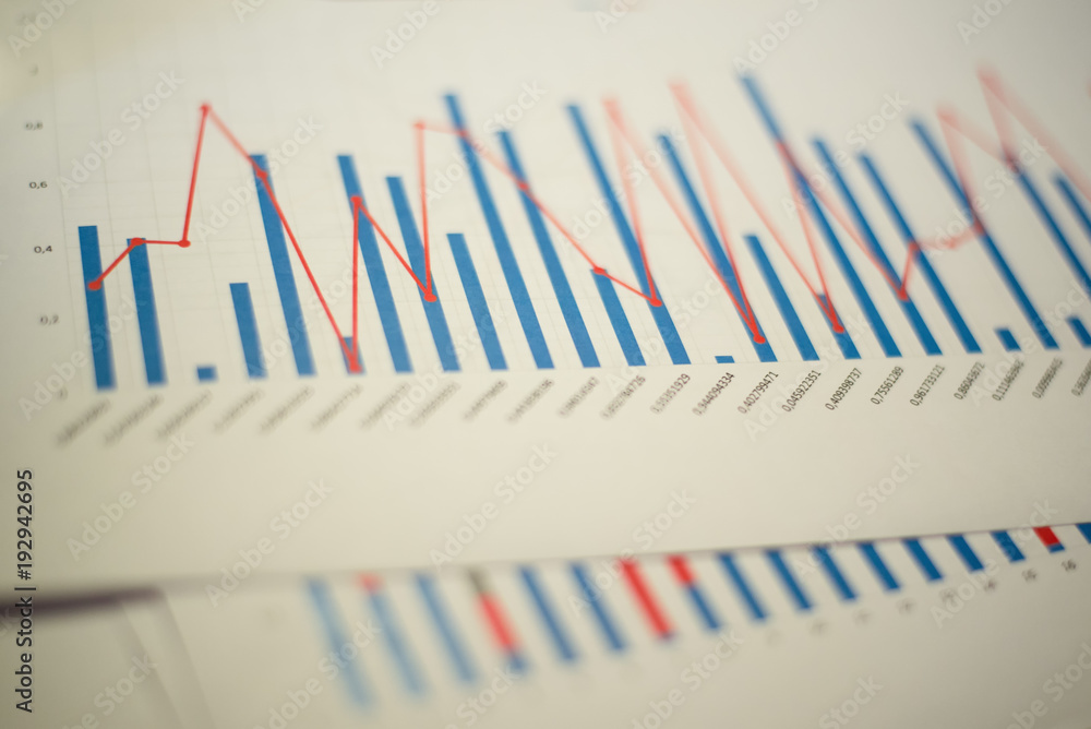 Business charts printed on sheets of paper during a meeting. Report ...