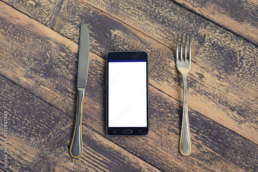 Mobile phone on the menu, with fork and knife. Order online concept ...
