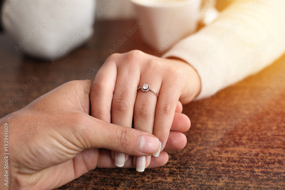 Closeup of couple hands on restaurant table. Romantic couple holding ...