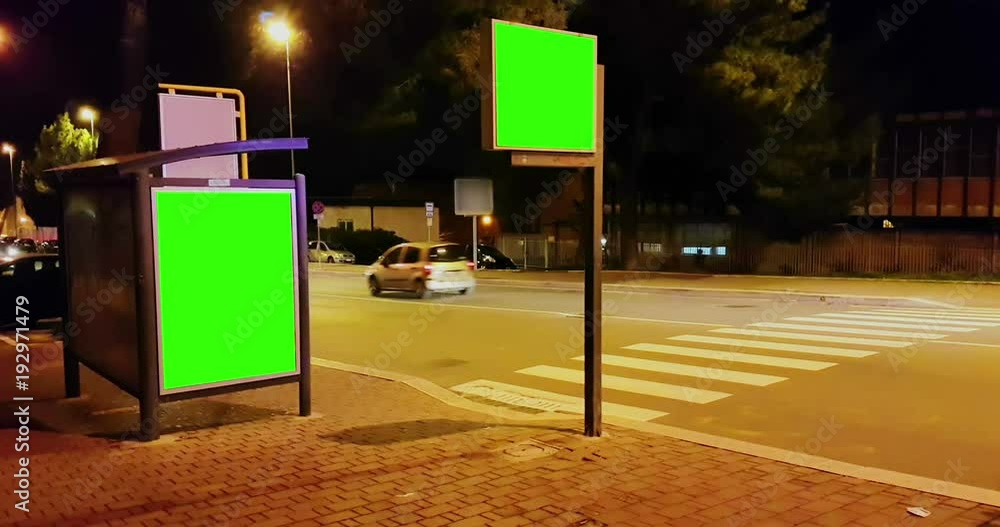 Billboard with a chroma key green screen on a traffic city night street ...