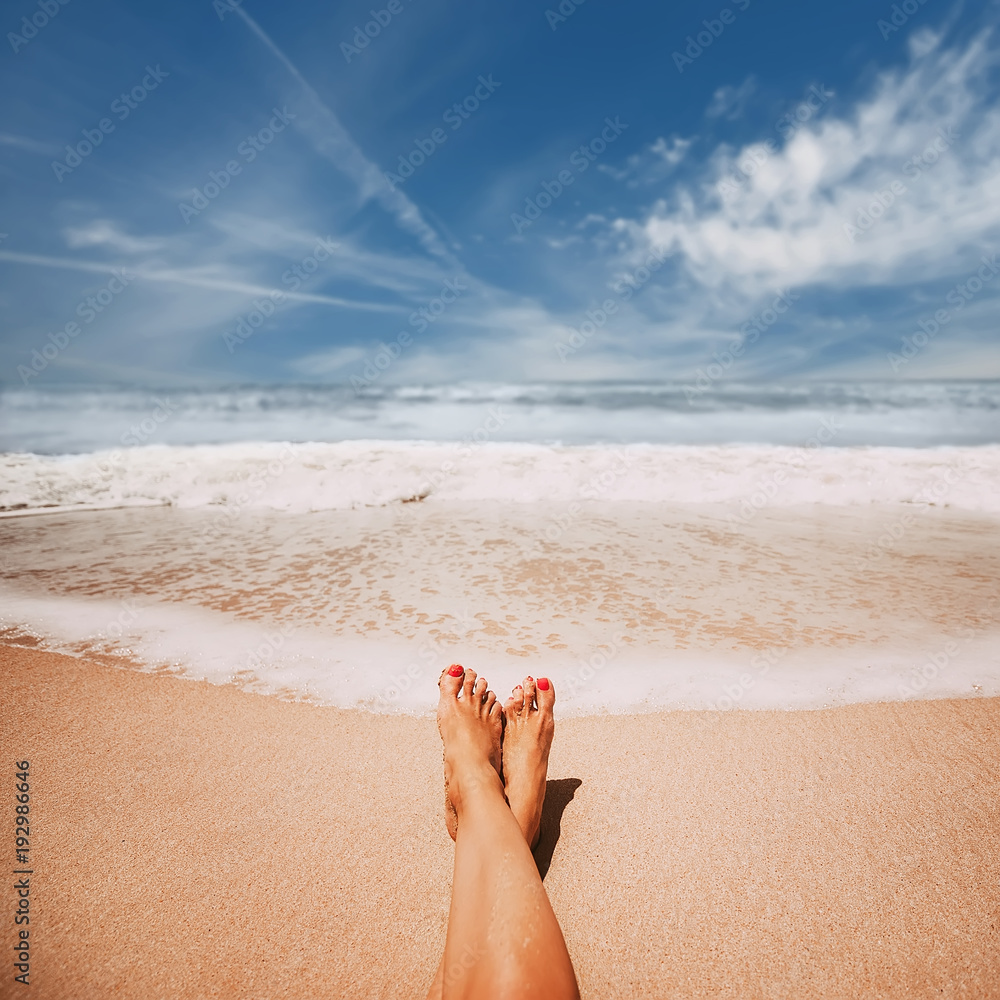 Female feet on sandy ocean beach. picture with soft focus and place for ...