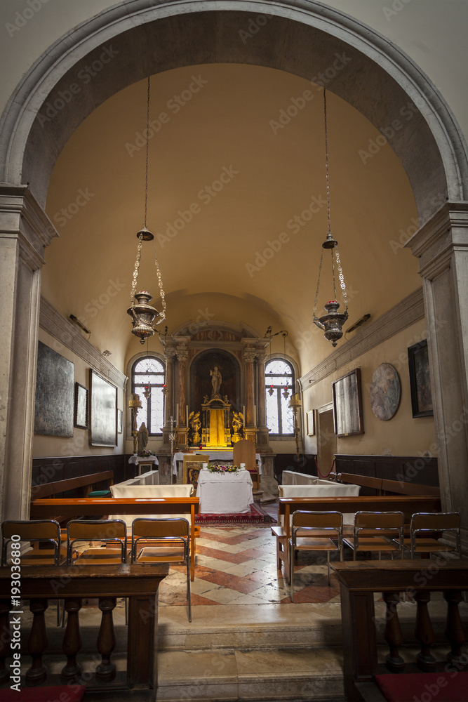 Modest interior of one of the many Catholic churches in Venice, Italy ...