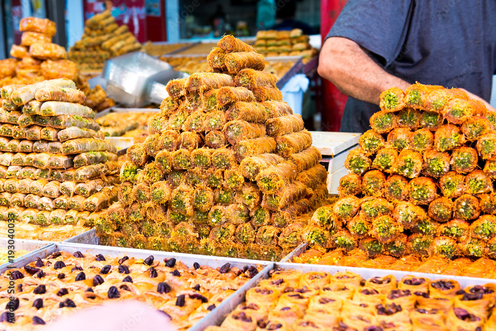 Variety of sweets on the arab street market stall. Eastern sweets in a ...