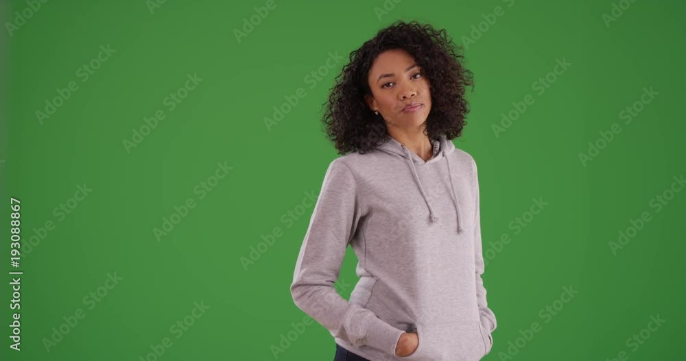 Pretty black woman taking a breath and closing eyes on green screen ...
