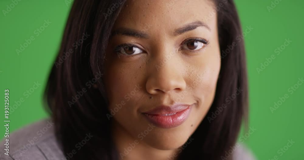 Close up of beautiful young black woman looking into camera lens on ...