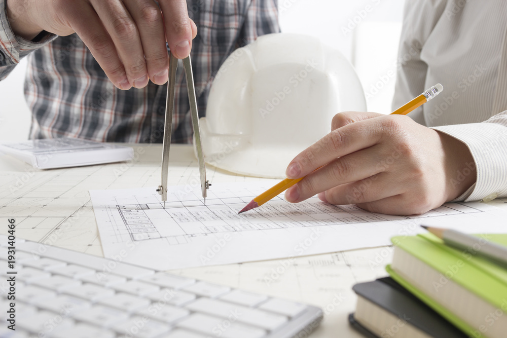 Architects working on blueprint, real estate project. Architect ...