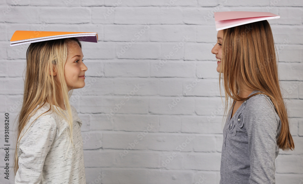 School girls with books on head. Education concept. Exercises for ...