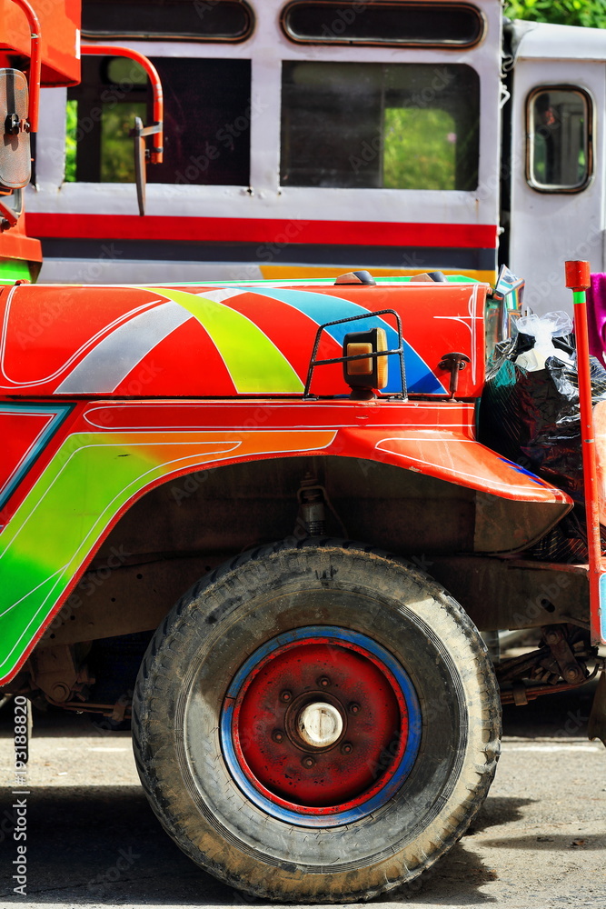Filipino orange-red dyipni-jeepney parked at the bus station. Sagada ...