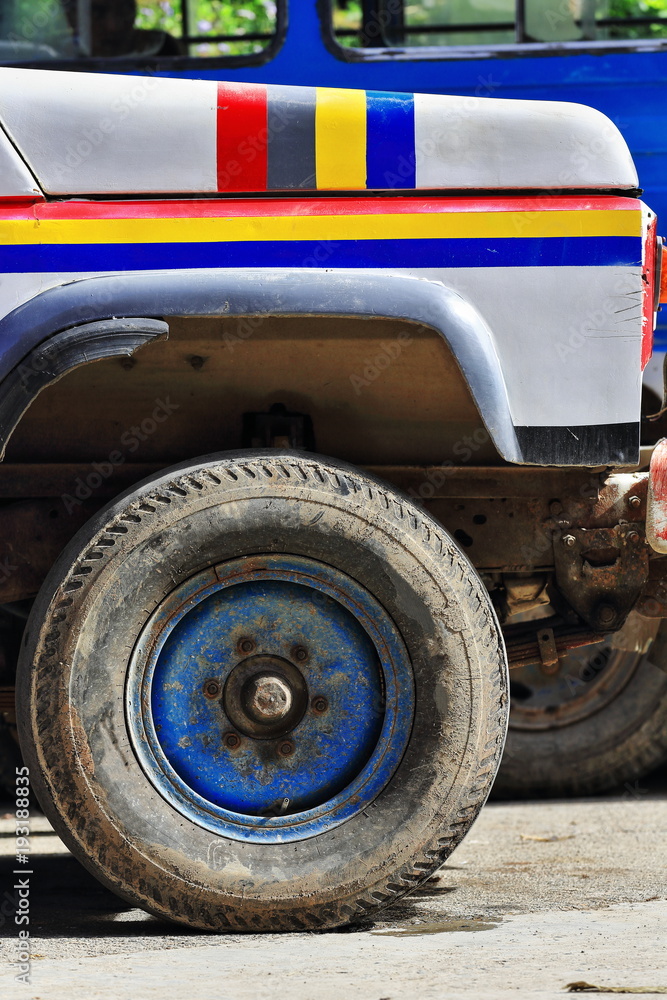 White-color striped dyipni-jeepney parked at the bus station. Sagada ...