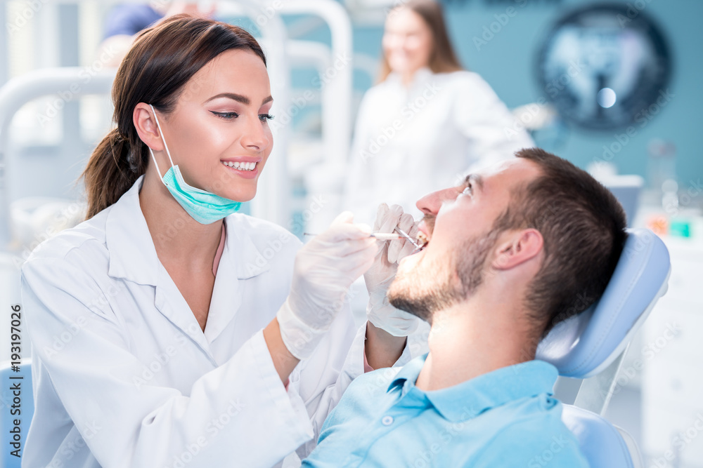 people, medicine, stomatology and health care concept - happy female dentist with mirror ...