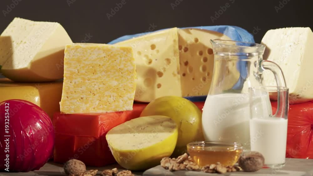 Cheese varieties. Different types of cheeses on wooden table. Stack of ...