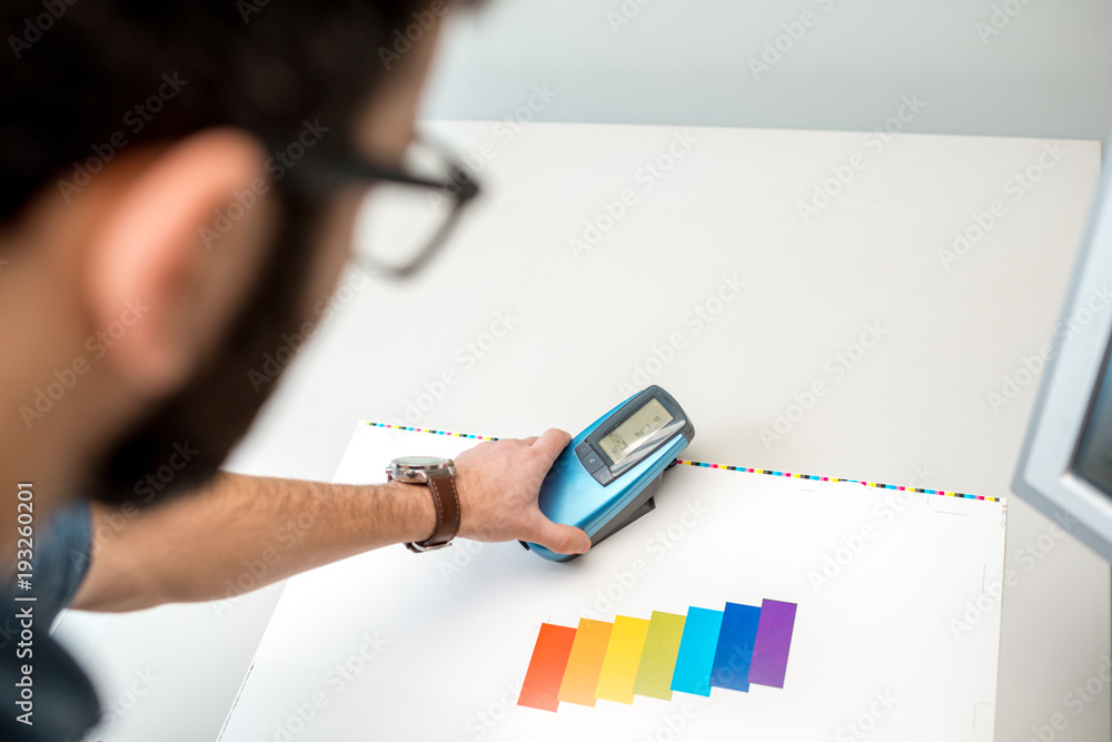 Measuring color on the paper print with spectrometer tool at the ...