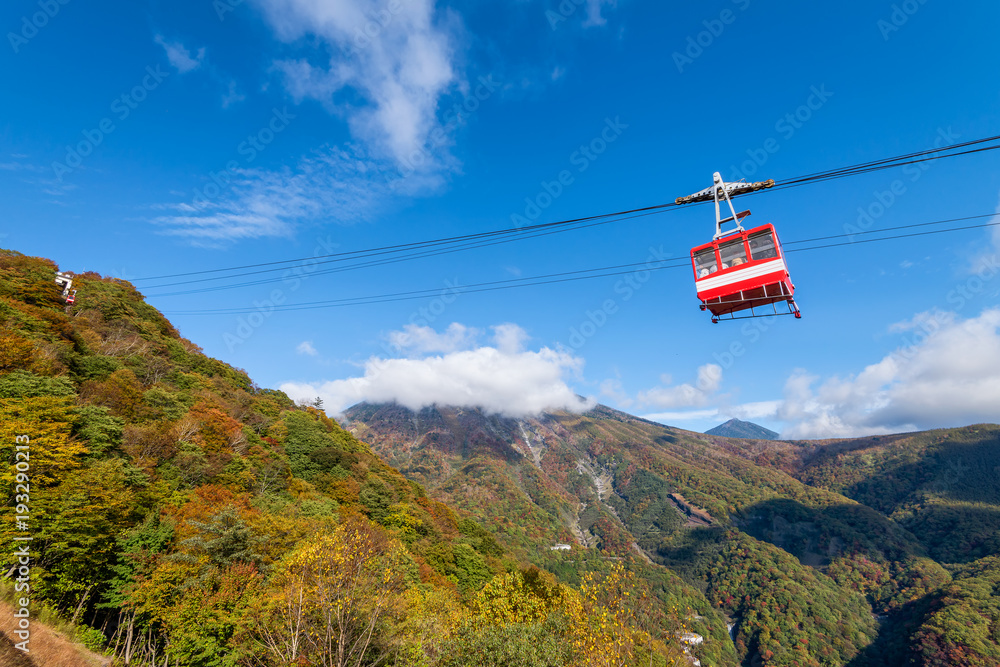 Red cable cars riding to Akechidaira observation deck with beautiful ...