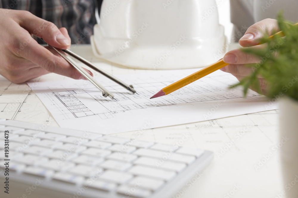 Architects working on blueprint, real estate project. Architect ...