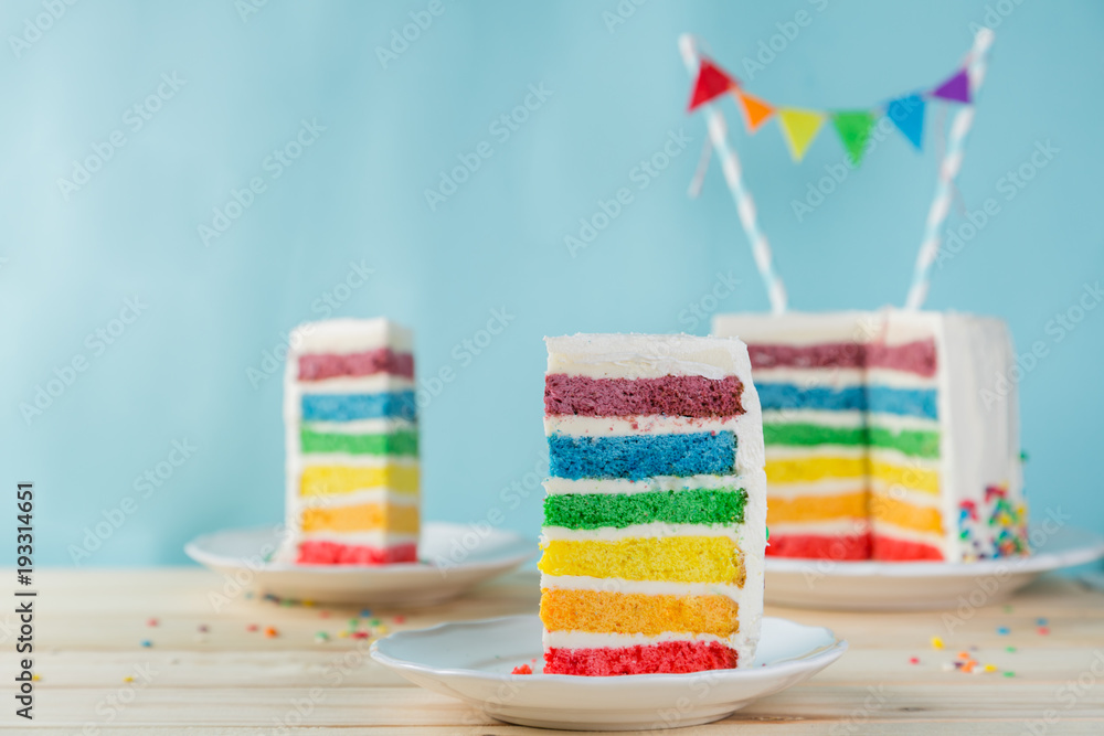 Birthday background - striped rainbow cake with white frosting Stock ...