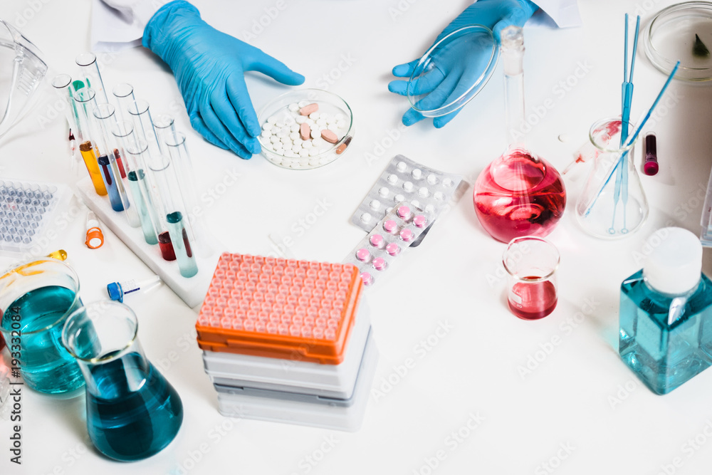 scientists holds pills in hand in laboratory. drug discovery ...