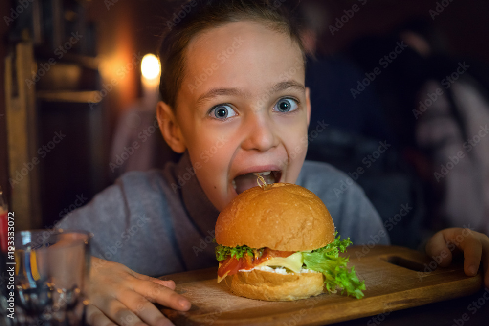 Teen Boy Eating Hamburger