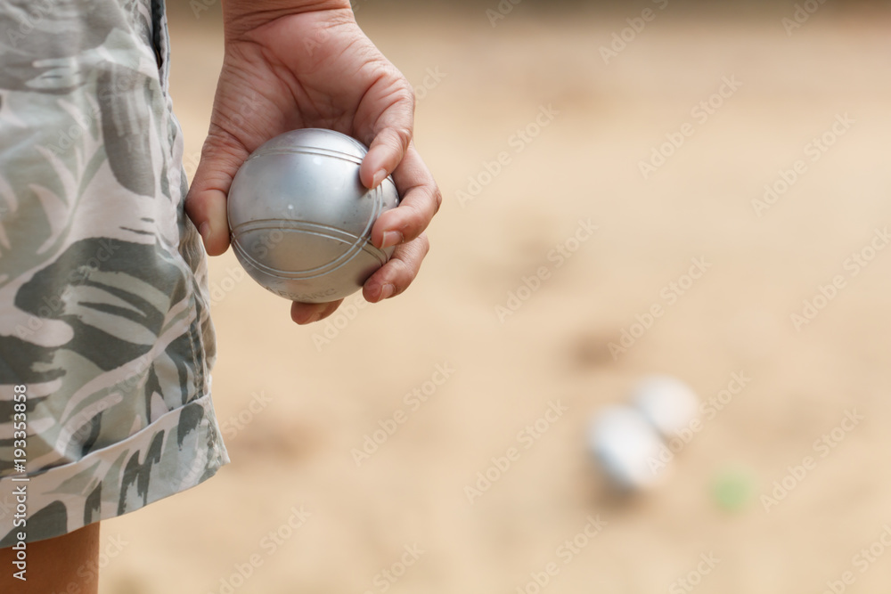 Hand of female boule holding boule or petanque ball on match Stock ...