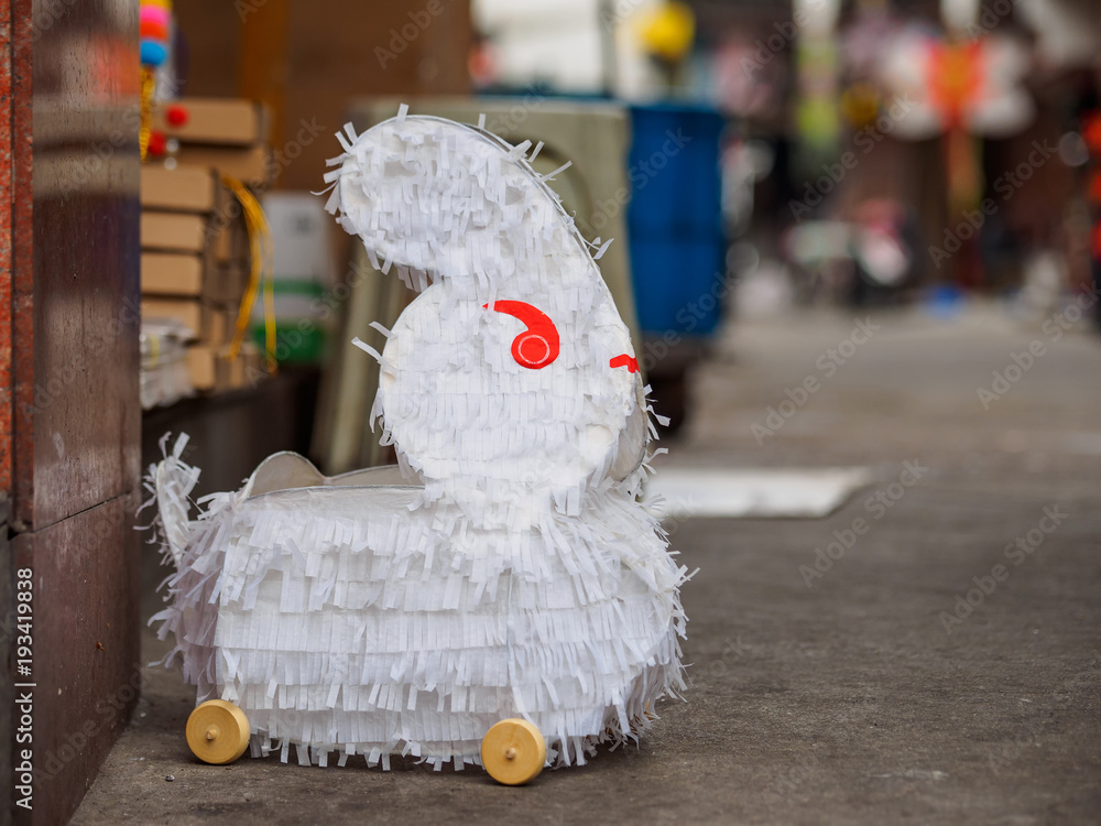 Cute white rabbit lantern made by paper on ground, it is a traditional ...