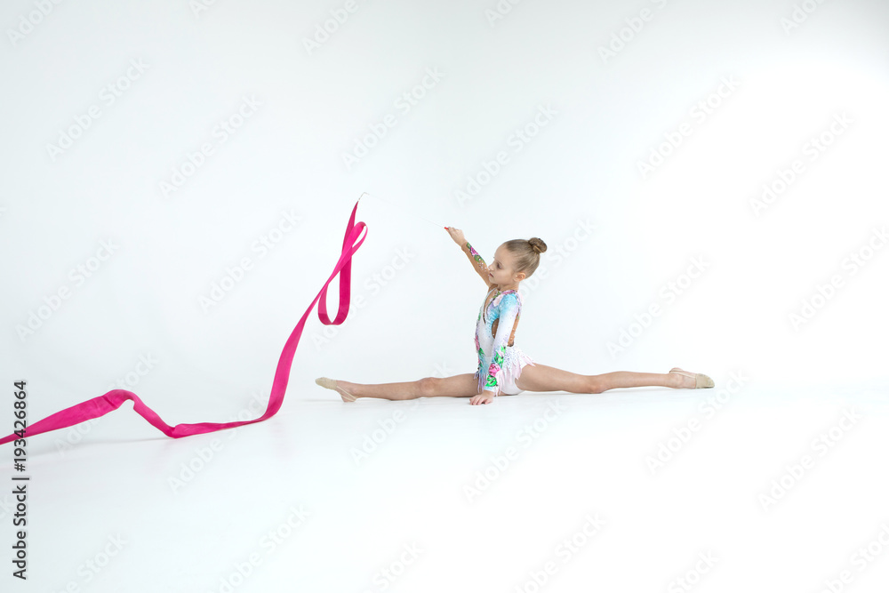 Rhythmic gymnastics caucasian blonde girl in dress for show performing ...