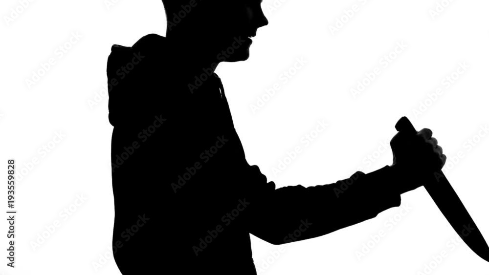 Maniac attacking victim by knife, dangerous criminal committing murder ...