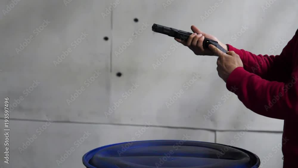 Close-up of a man hands holding and loading gun magazine in the pistol ...