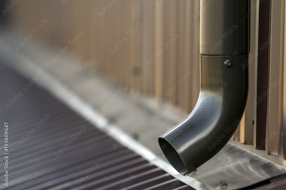 Brown new gutter metal system pipe. Vertical construction for draining ...