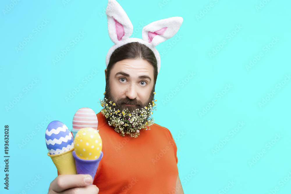 Happy Easter concept. Nice kind muscle man male with flower's beard ...