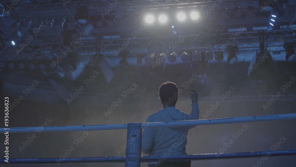 Back view of working gaffer or lighting technician and spotlights ...