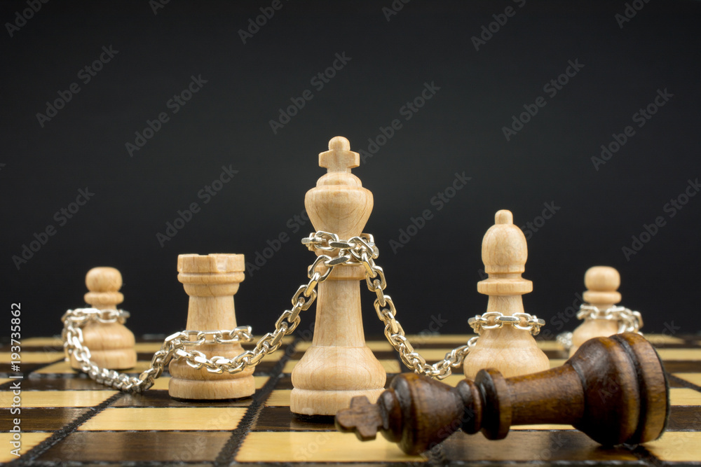 the chess king bishop castle rook knight is bound by a chain on a ...