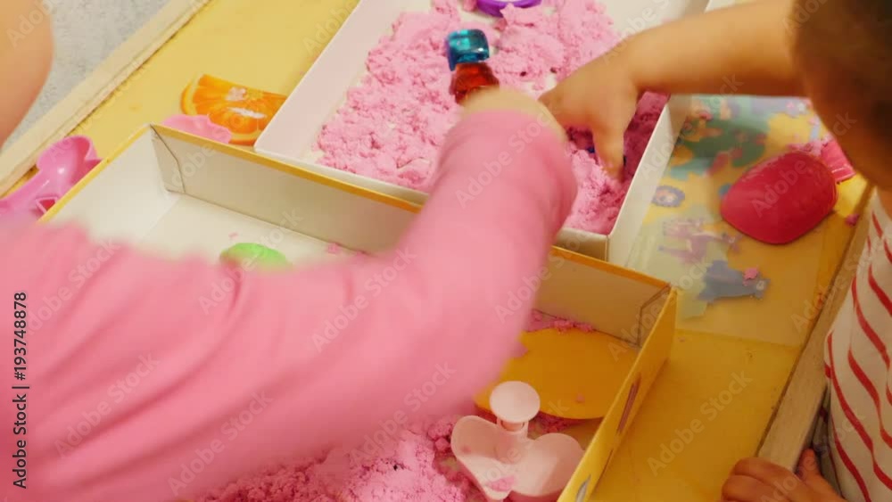 Children playing with pink play sand/magic sand Close-up/closeup shot ...