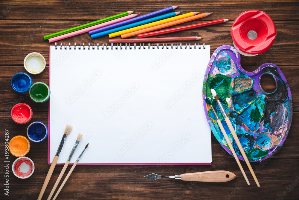 Set of paints, pencils, tools for painting and blank white paper sheet ...