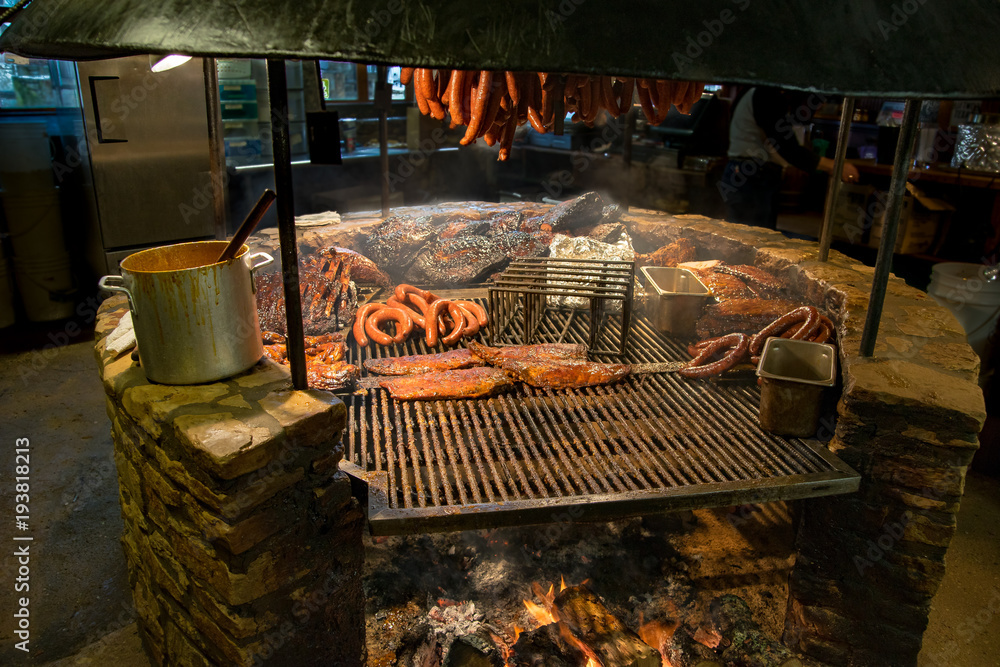 Texas style BBQ pit smoked meat ribs sausage over flame Stock Photo ...