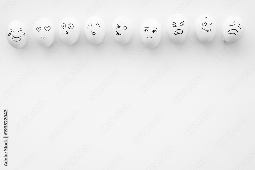 Basic emotions concept. Faces drawn on eggs. Happy, smile, sad, angry ...