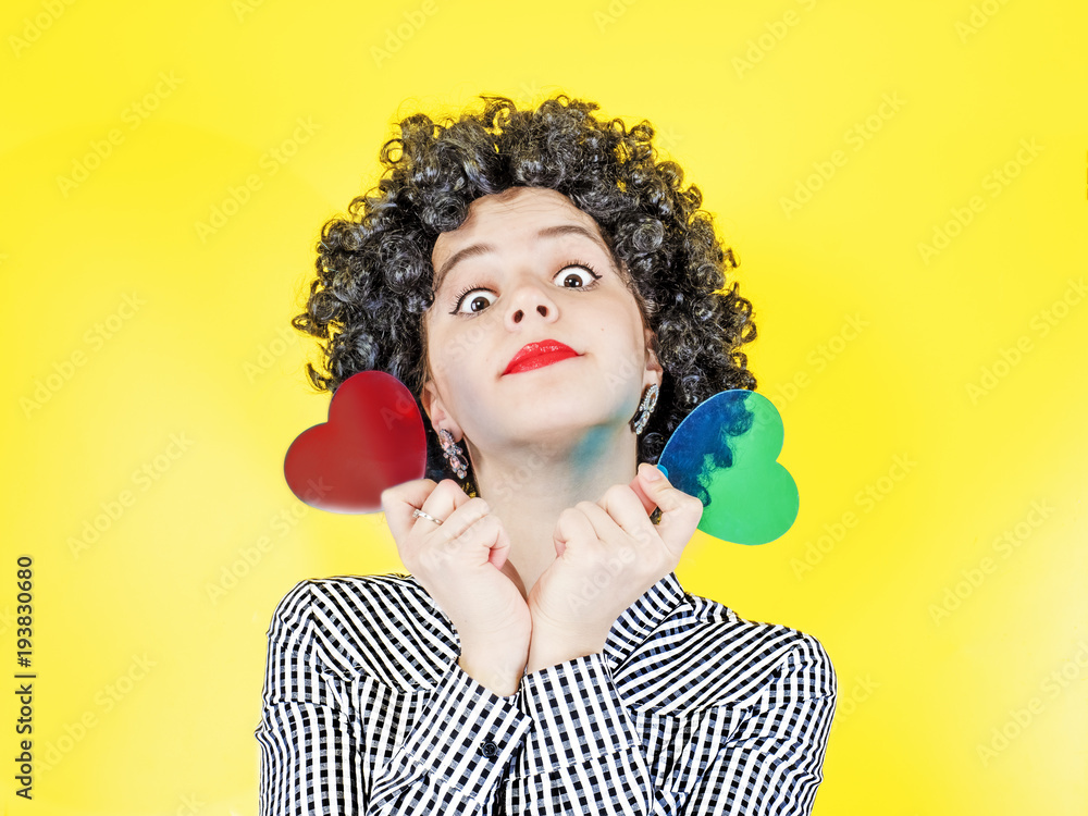 Portrait of a young girl with afro hair with glass heart shape on a ...
