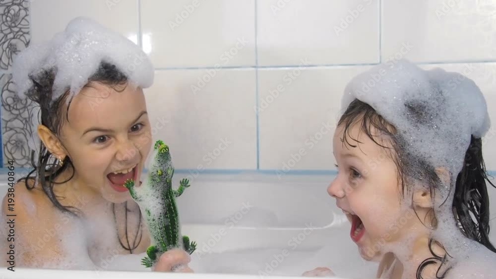 Children take a bath. Little girls are playing in the bathroom. Stock ...