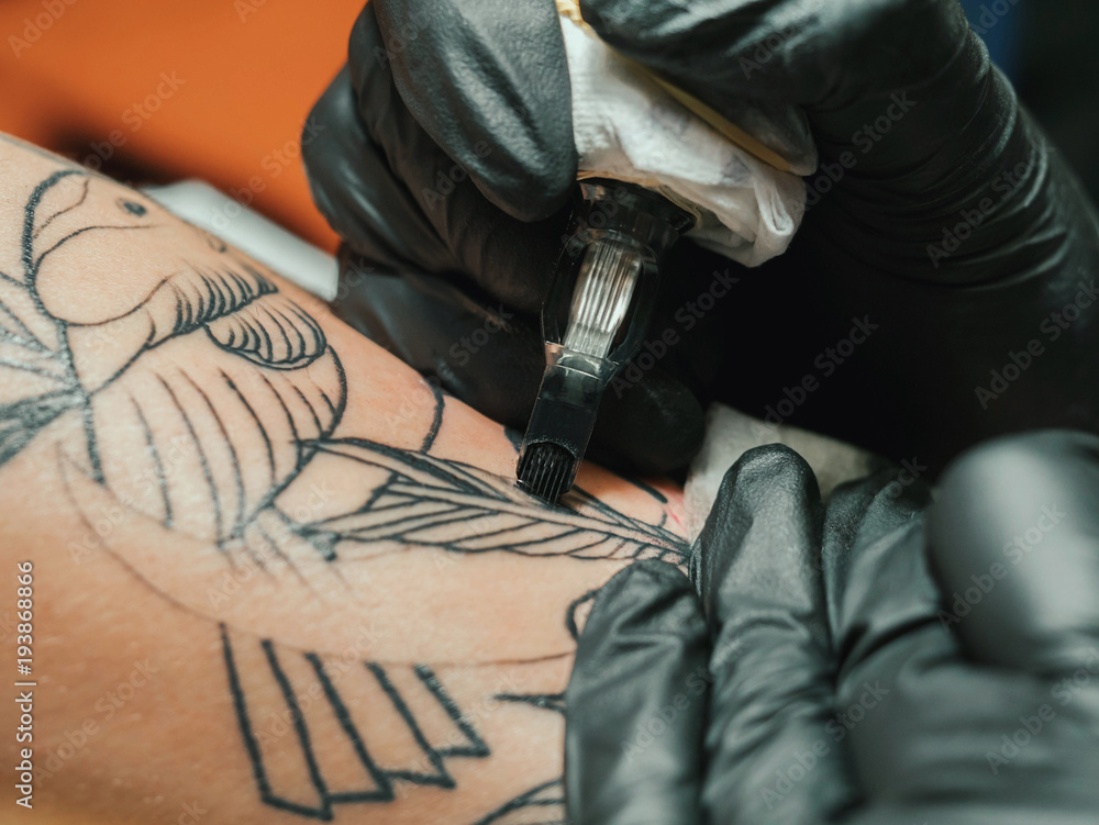 Tattoo Artists Hands At Work