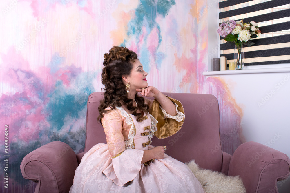 beautiful young woman with makeup, hairdo and in a beautiful ballroom ...