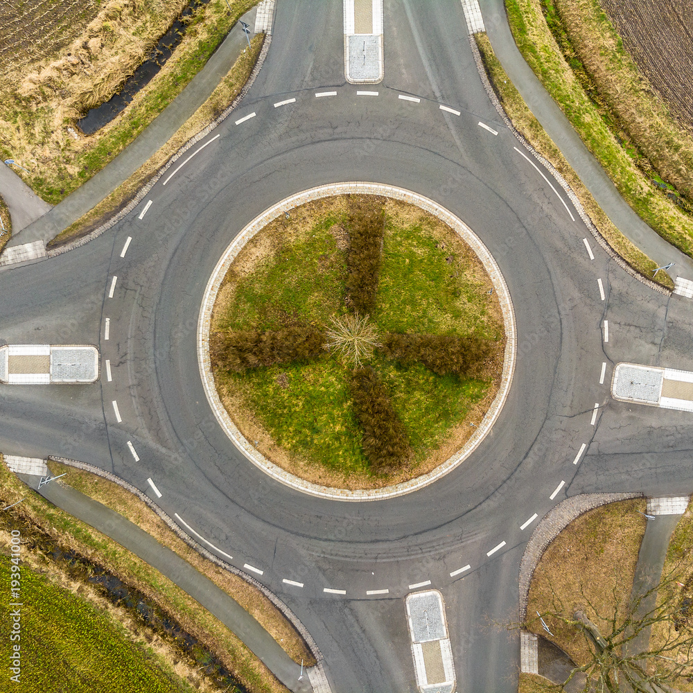 Aerial view of a small roundabout at the intersection of two asphalted ...