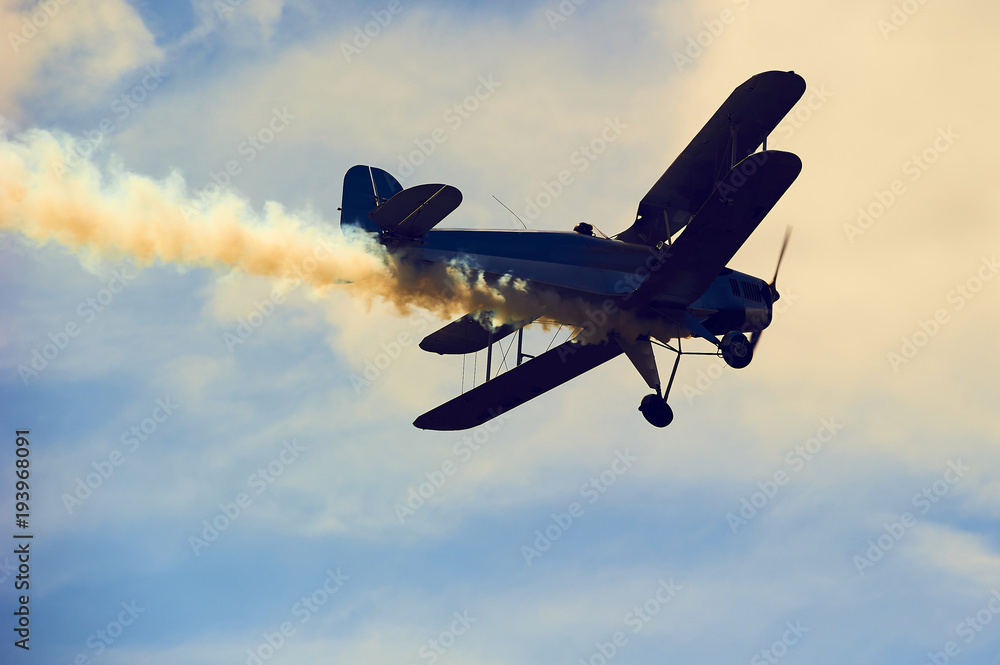 Vintage single engine propeller biplane aircraft flying against sky ...