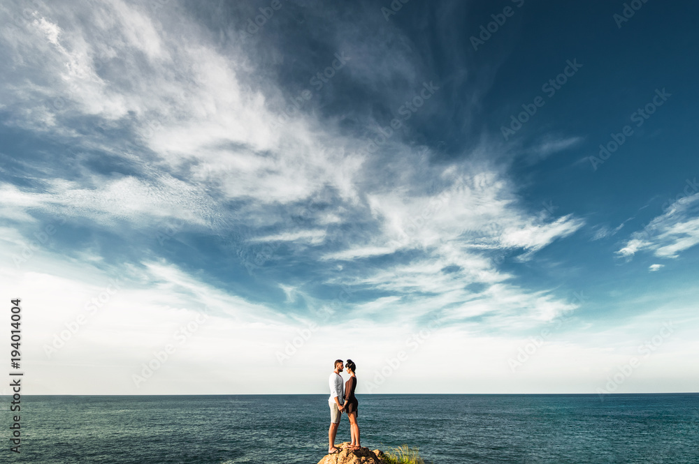 Couple in love at the top of the mountain. Guy and girl on the beach ...